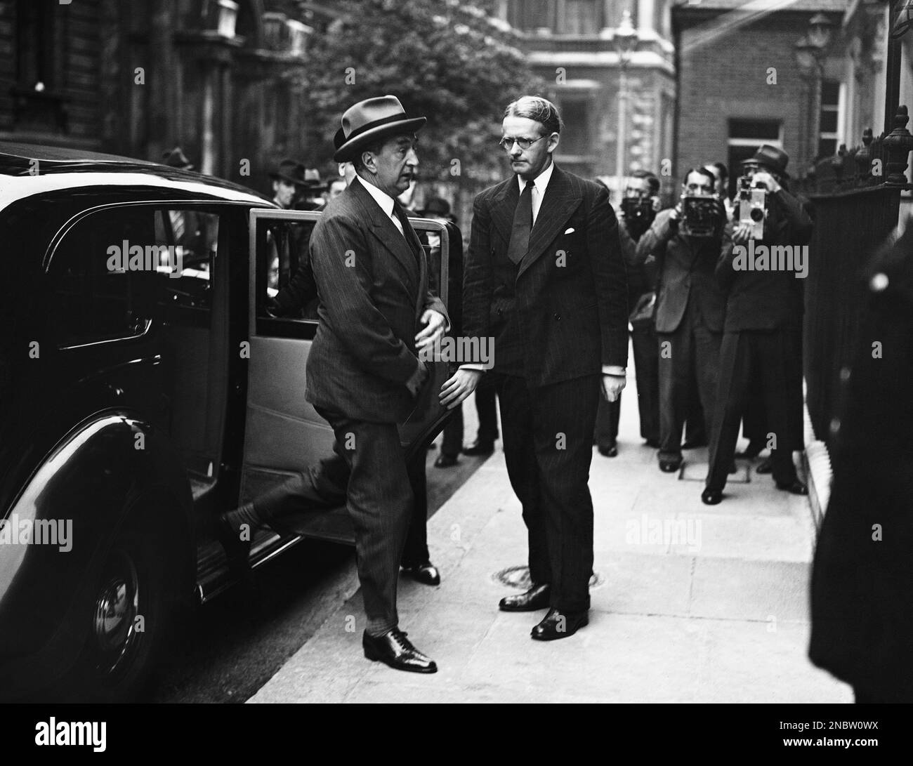 Australian High Commissioner Stanley Bruce steps out of his car at the ...