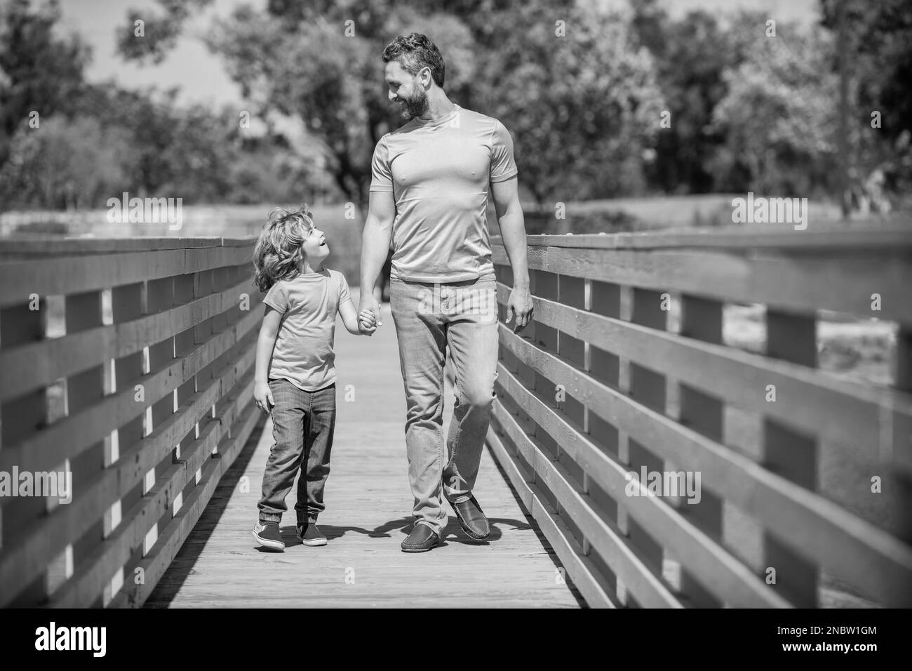 cheerful single father leading small child outside, charity Stock Photo ... cheerful single father leading small child outside, charity Stock Photo ...