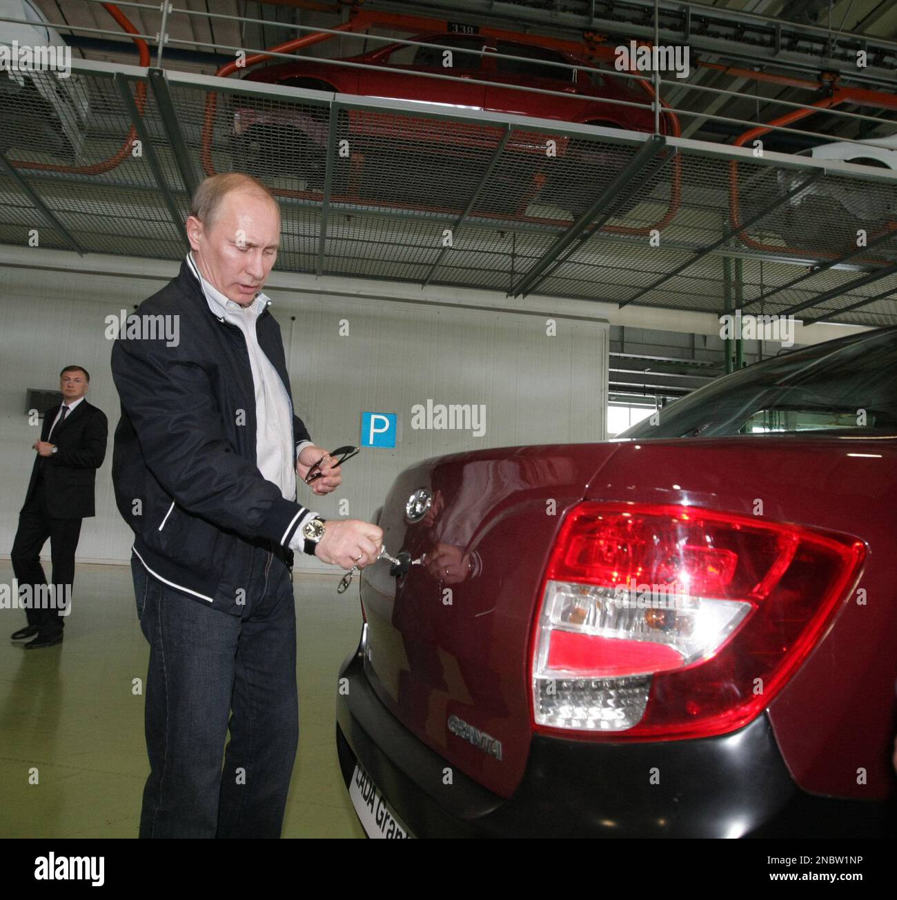 Prime Minister Vladimir Putin opens a trunk of a new Lada-Granta car ...