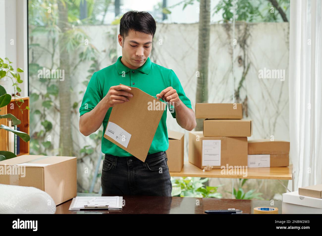 Serious solopreneur opening letter with important documents form bank ...