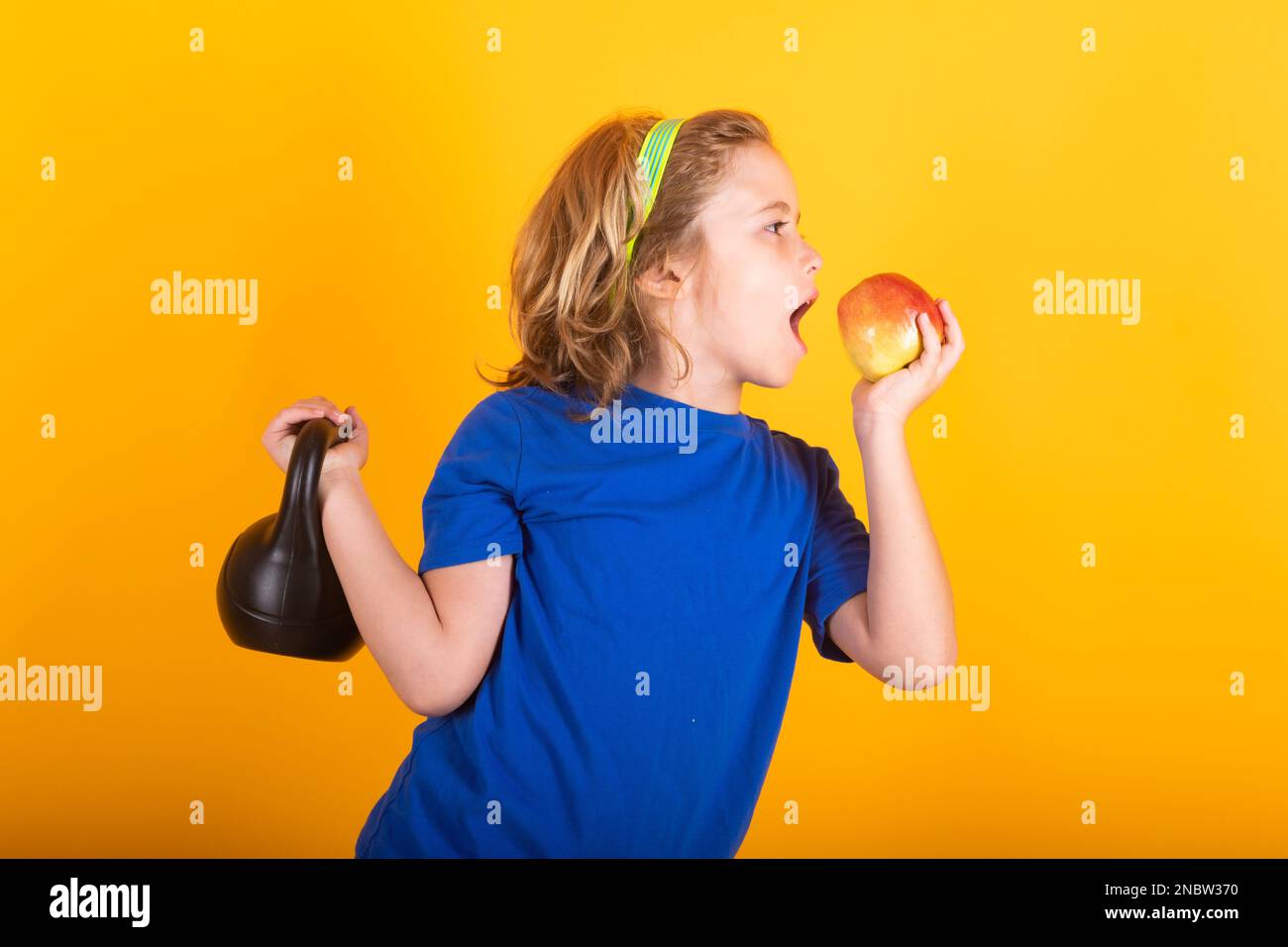 Sport activities at leisure with children. Blonde boy holding kettlebell. Sports exercises for ...