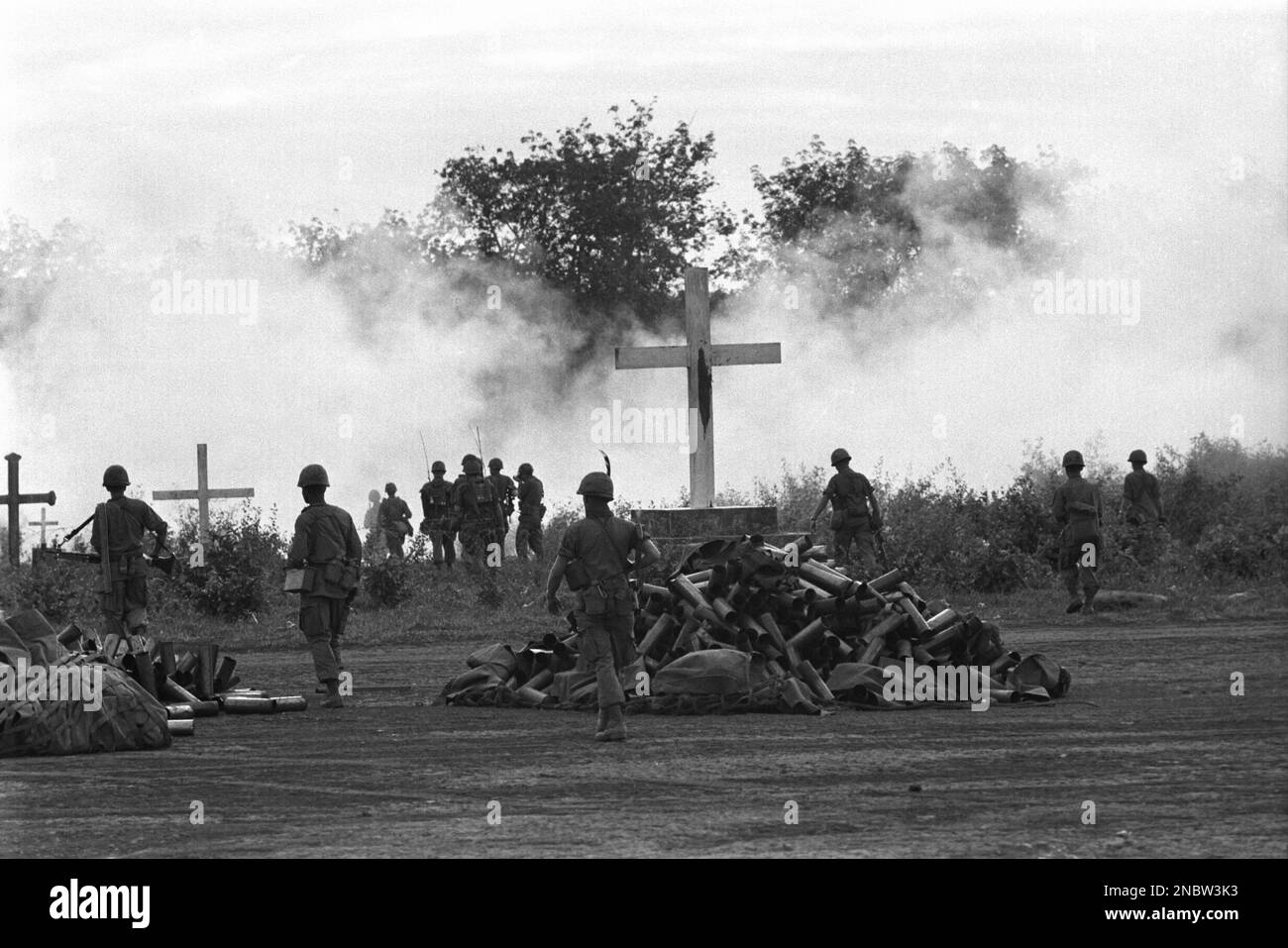 American troops cross a graveyard into the smoke of an artillery ...