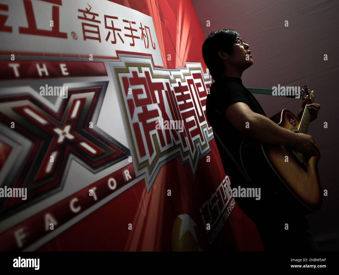 A contestant sings as he takes part in an audition for the "X Factor ...