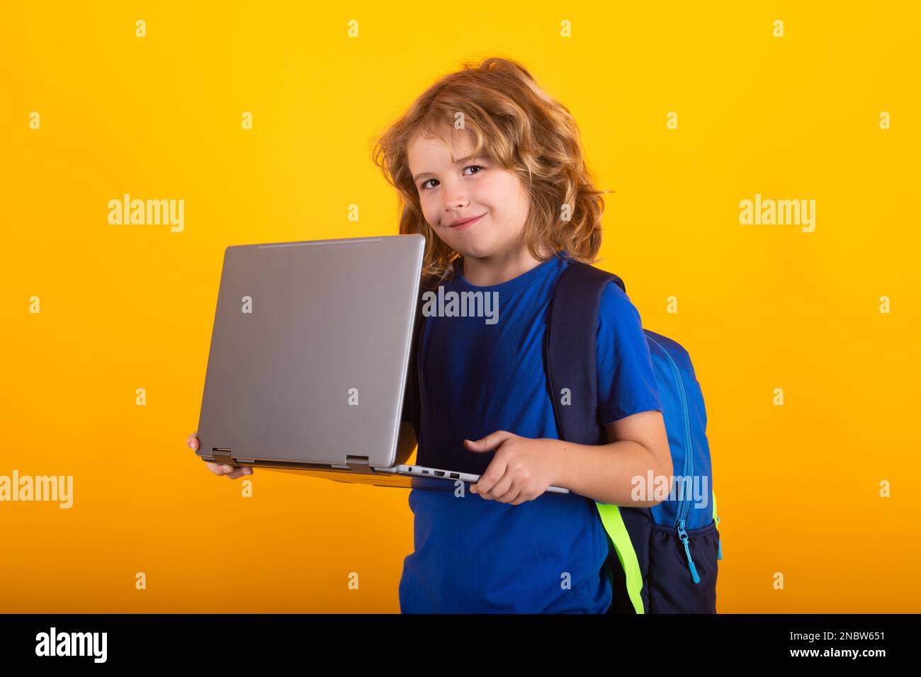 School child using laptop computer. Nerd school kid isolated on studio ...
