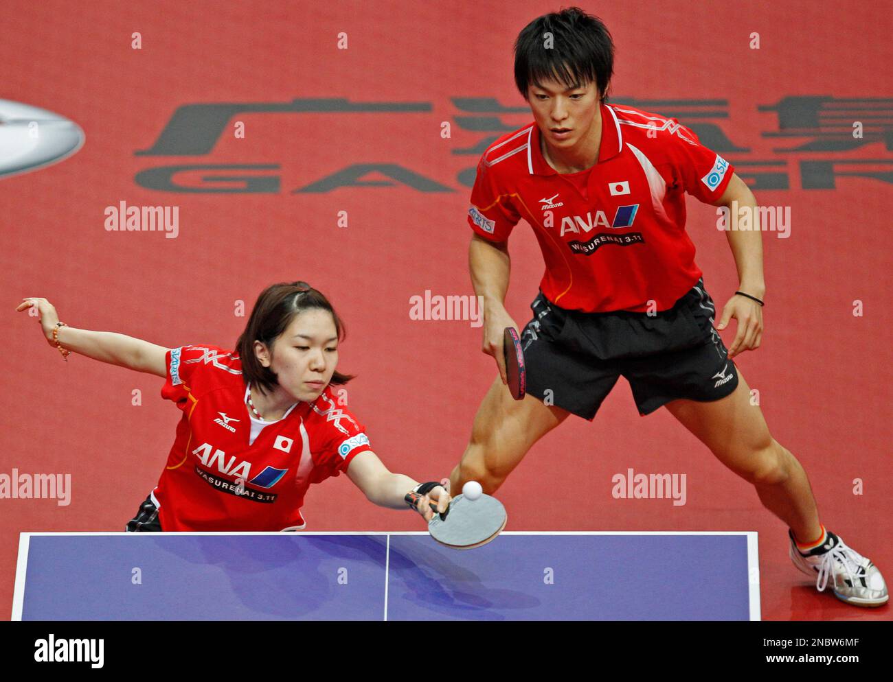 Japan's Kenji Matsudaira, right, and Misako Wakamiya, left, compete against Congo's Saheed Idowu ...