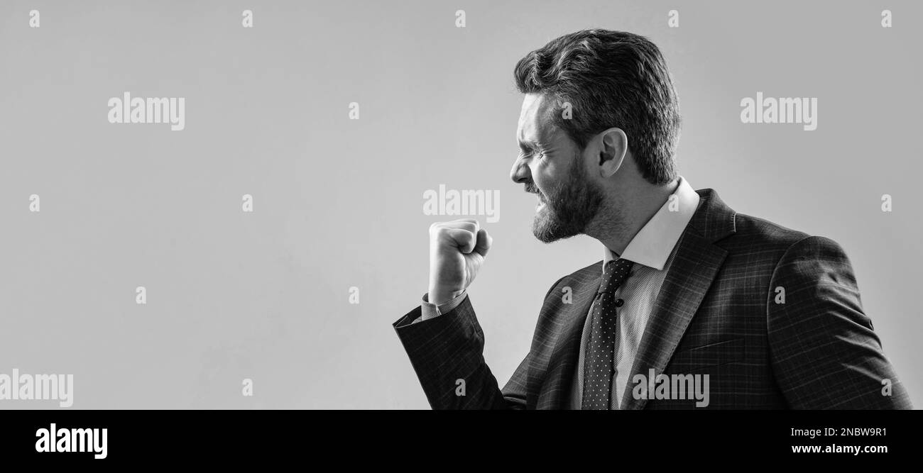 Aggressive man businessman in suit make threaten gesture shaking fist ...
