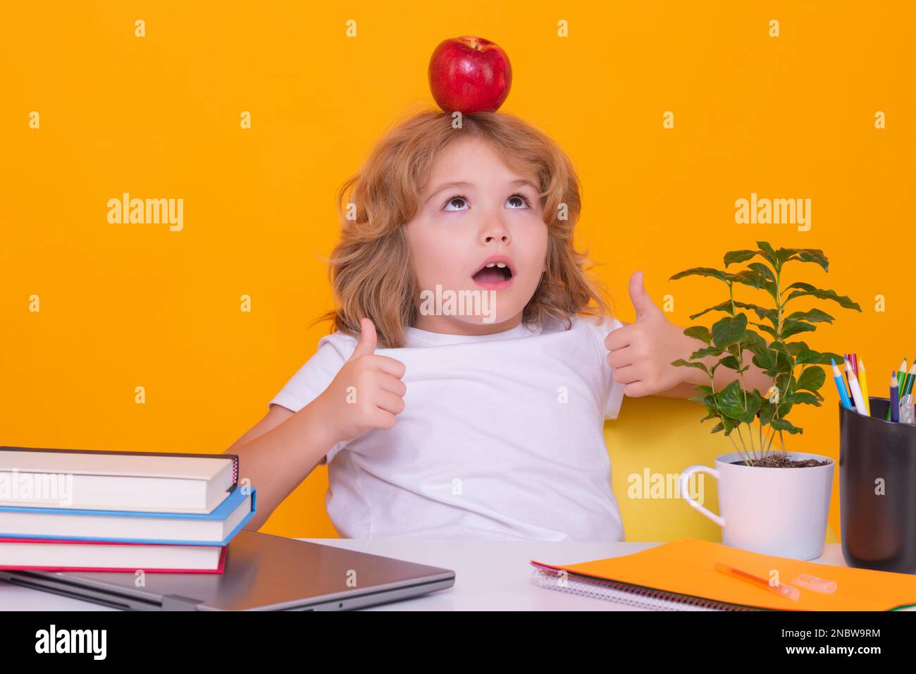 Funny pupil. School and kids. Cute blonde child with a book learning ...