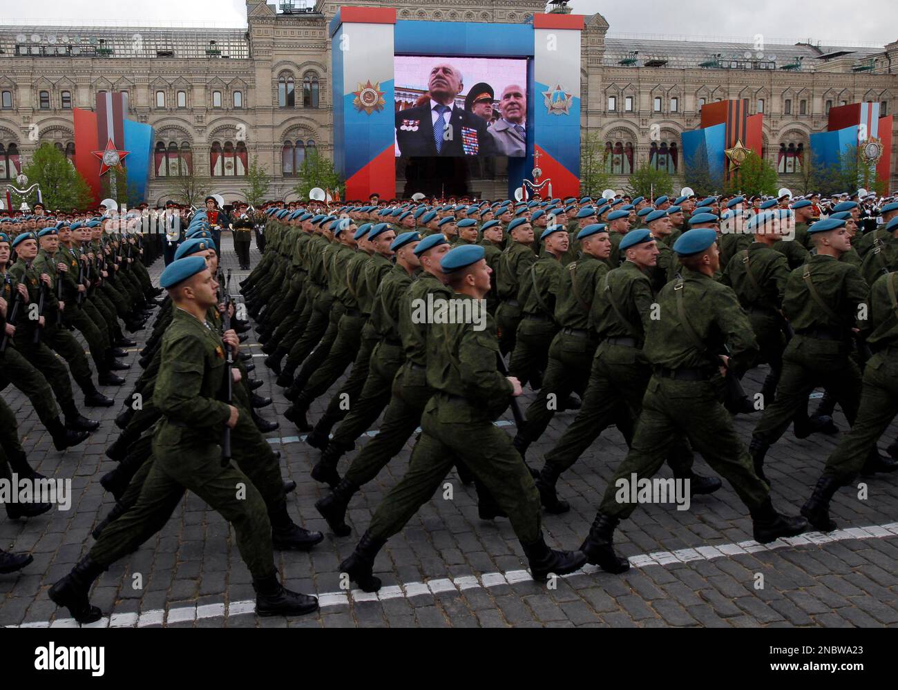 Russian World War II veterans are seen on a giant screen watching as ...