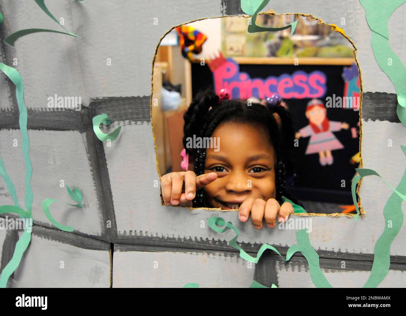In this photo made Thursday, March 10, 2011, Imani Cooper peeks out of ...