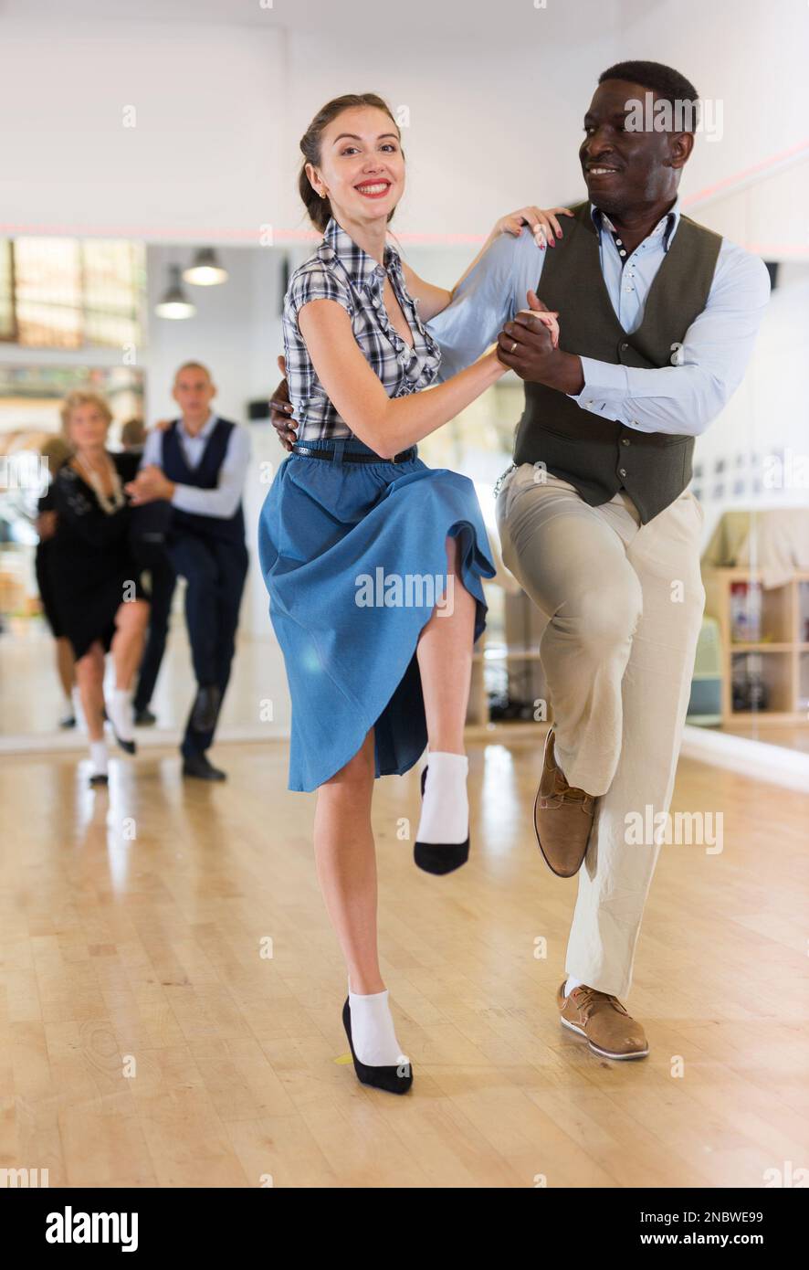 Woman and man dancing swing in studio Stock Photo - Alamy