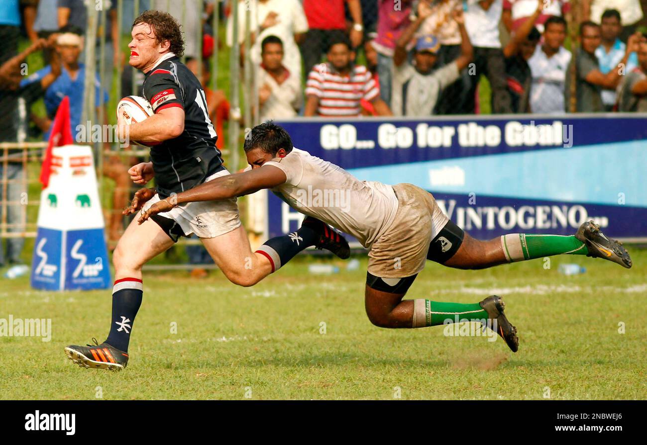 Hong Kong's Alex Ng charges as Sri Lankan Danushka Perera tries an ...