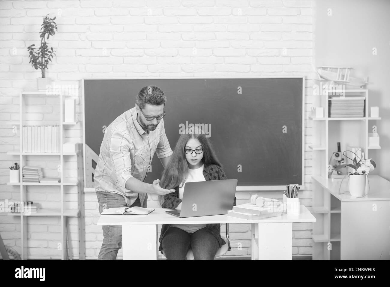 back to school. childhood education. busy pupil and tutor with laptop ...