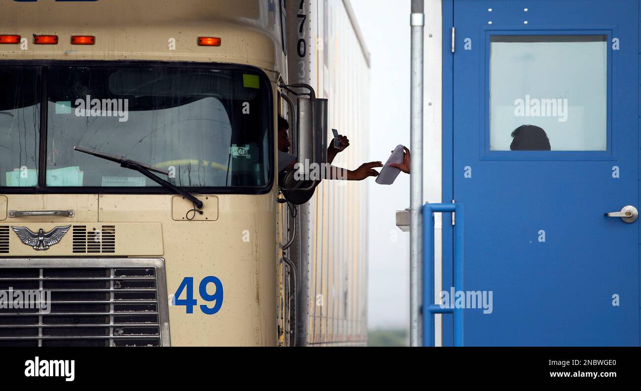 Truckers pass through inspection booths for commercial traffic heading ...