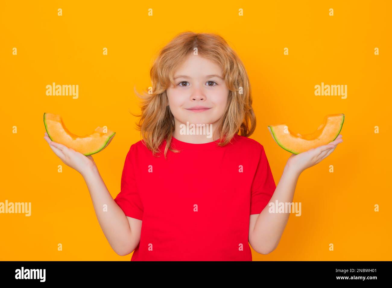 Healthy fruits for kids. Child hold red melon in studio. Melon fruit ...