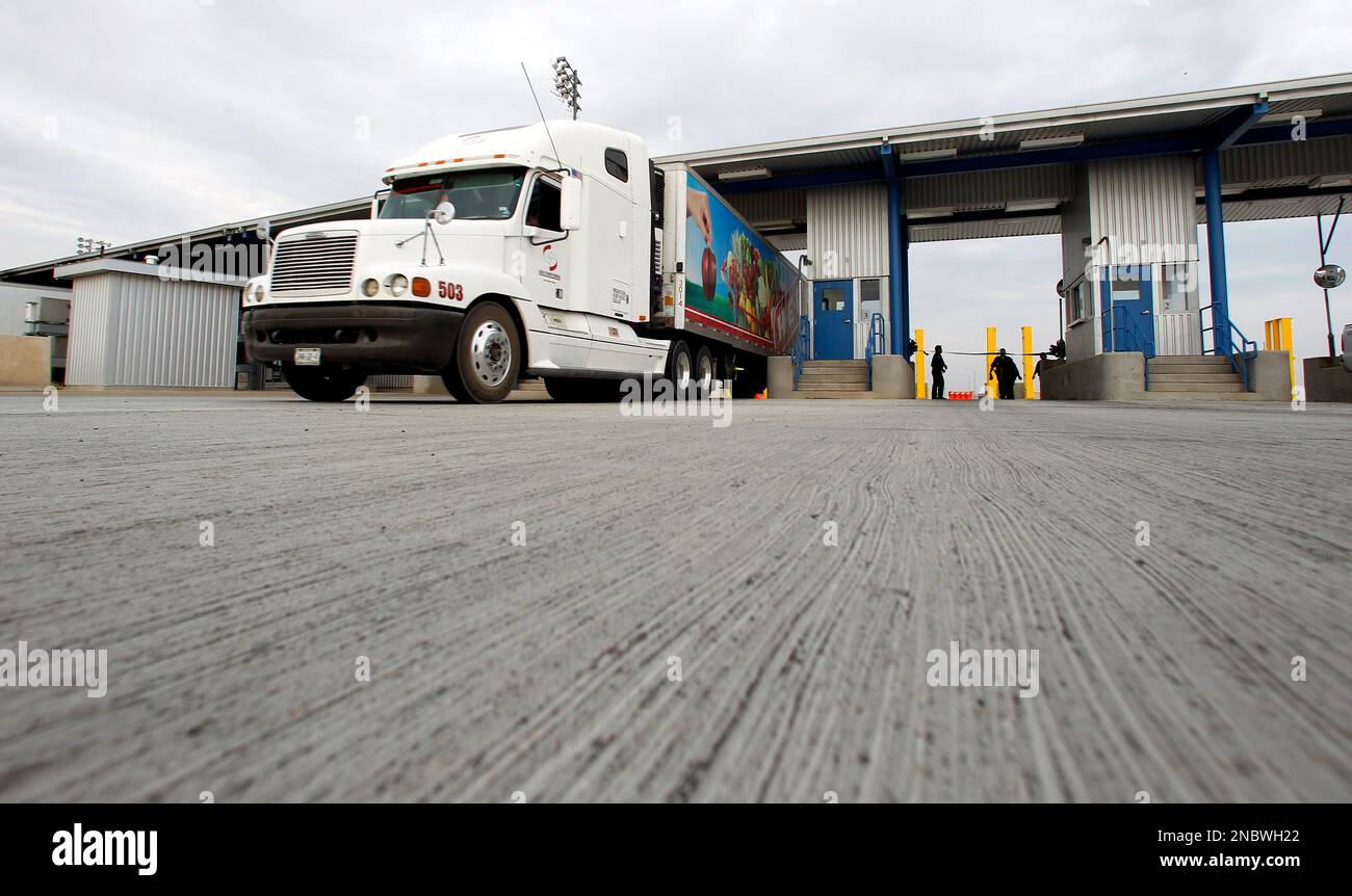 Truckers pass through inspection booths for commercial traffic heading ...