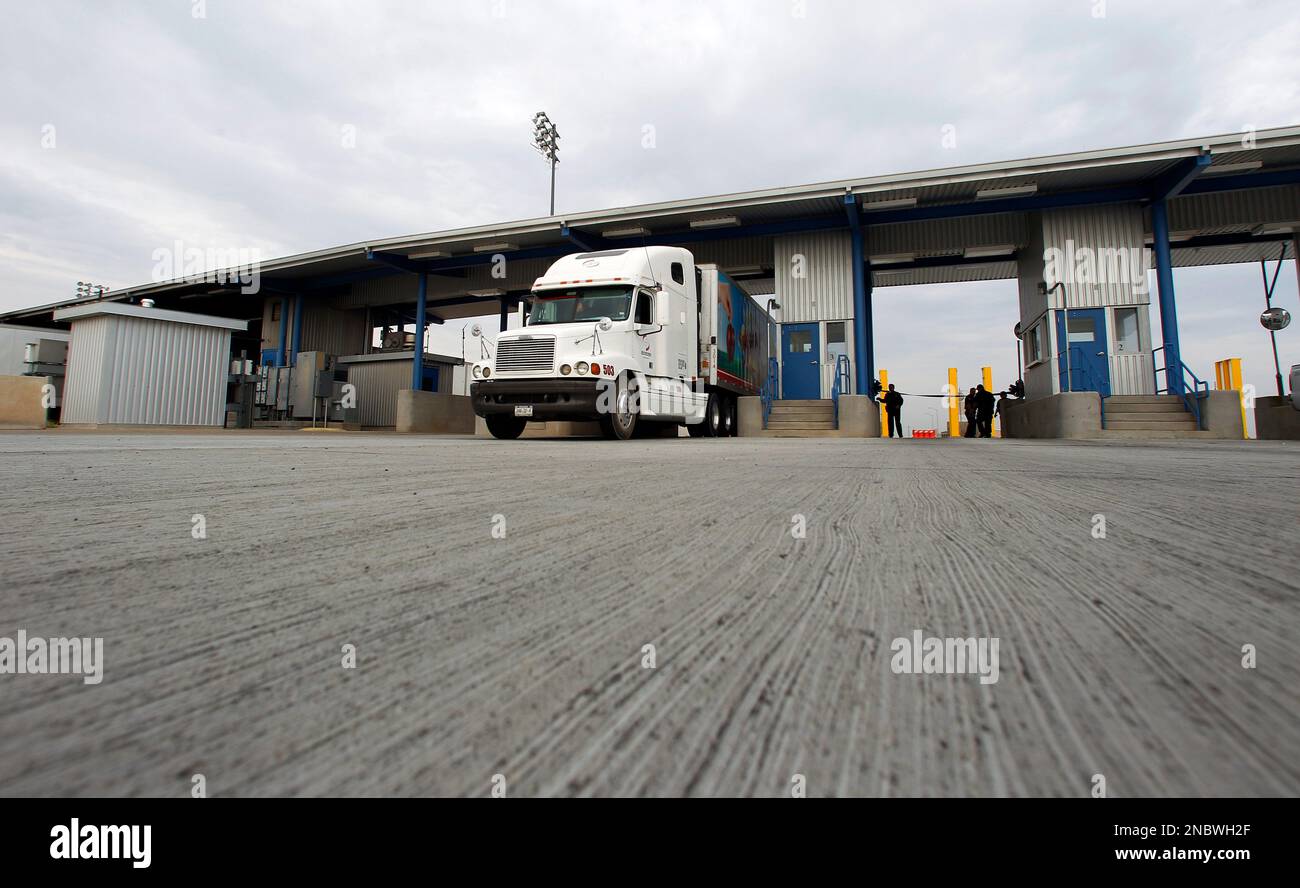 Truckers pass through inspection booths for commercial traffic heading ...