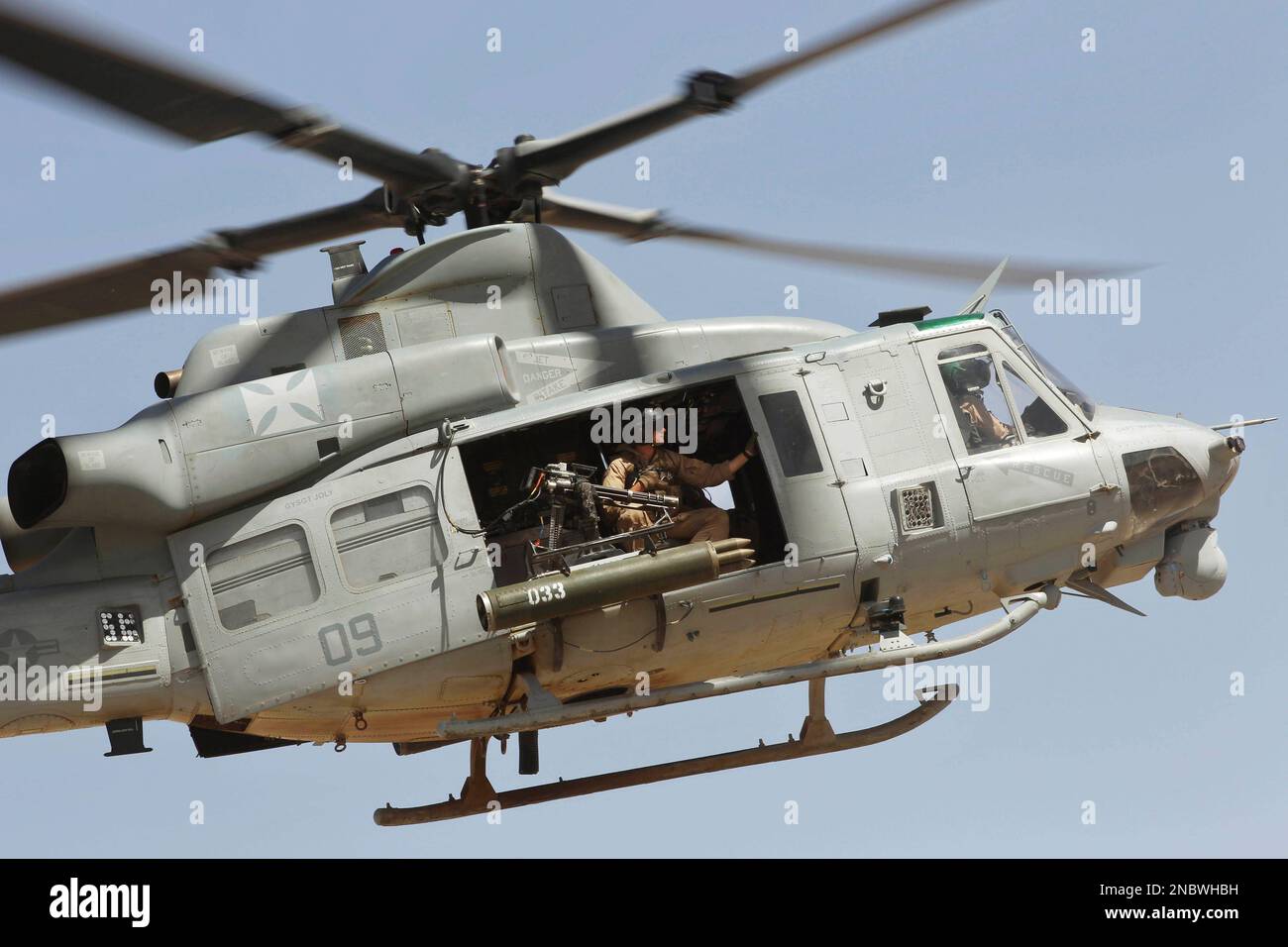 A United States Marine armed Super Huey helicopter flies above Forward ...