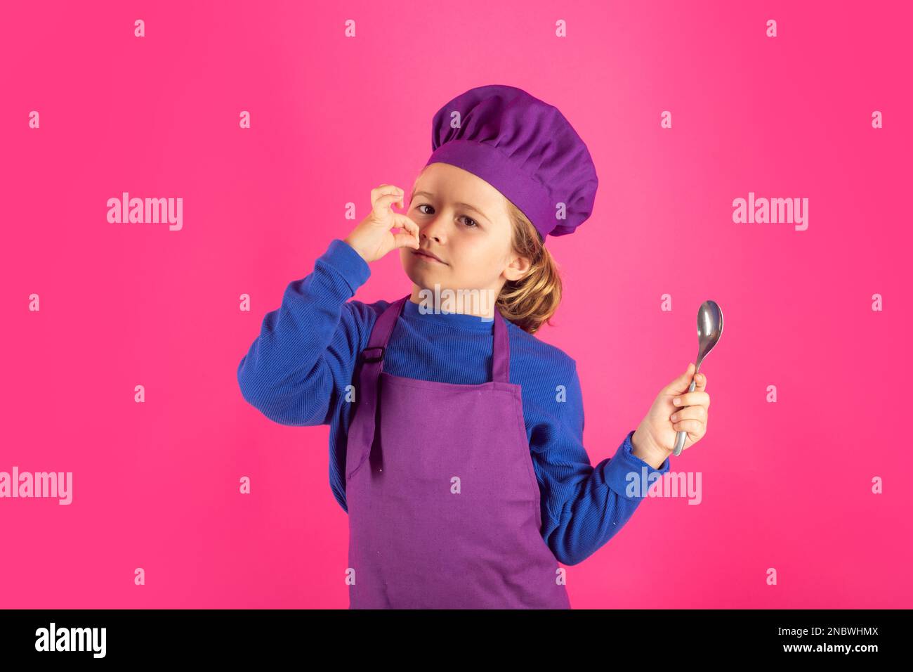 Funny kid chef cook with spoon. Chef kid boy making healthy food ...