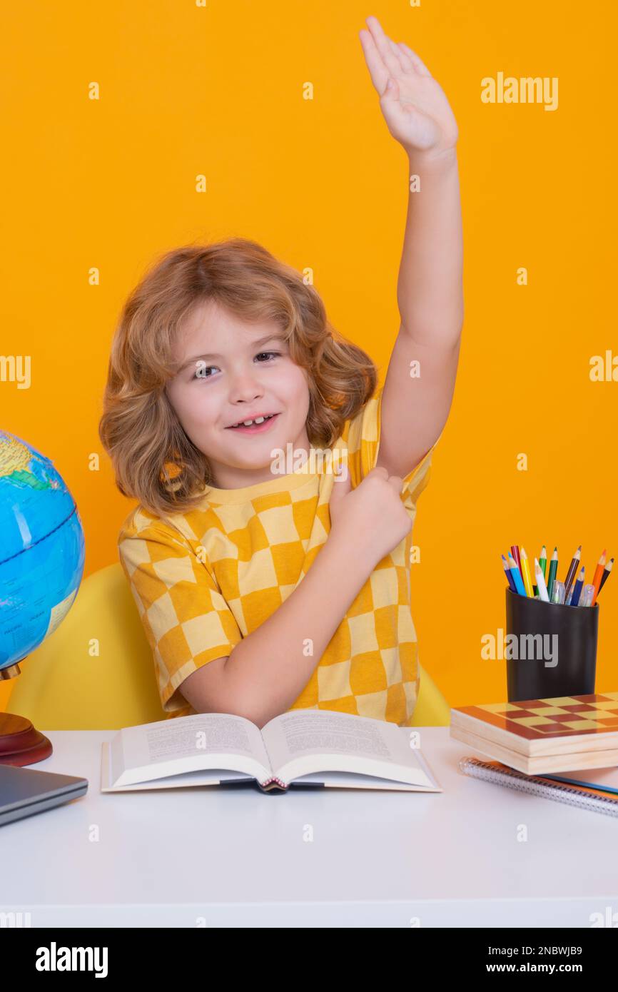 Schoolchildren raising hands in class hi-res stock photography and ...