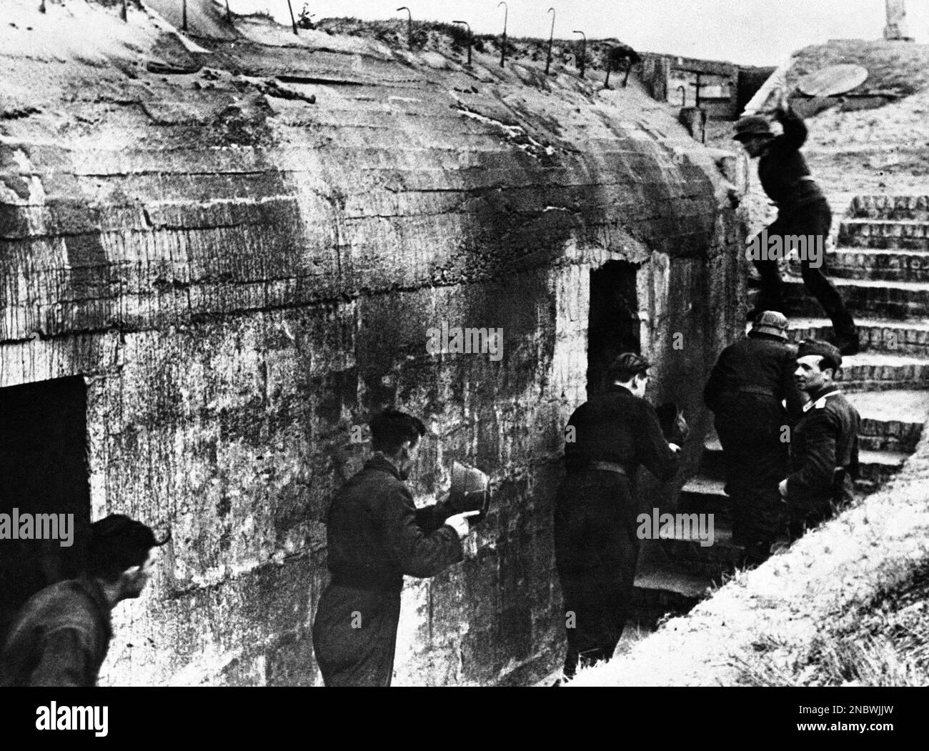 German soldiers pour from a bunker in the French Channel Coast ...