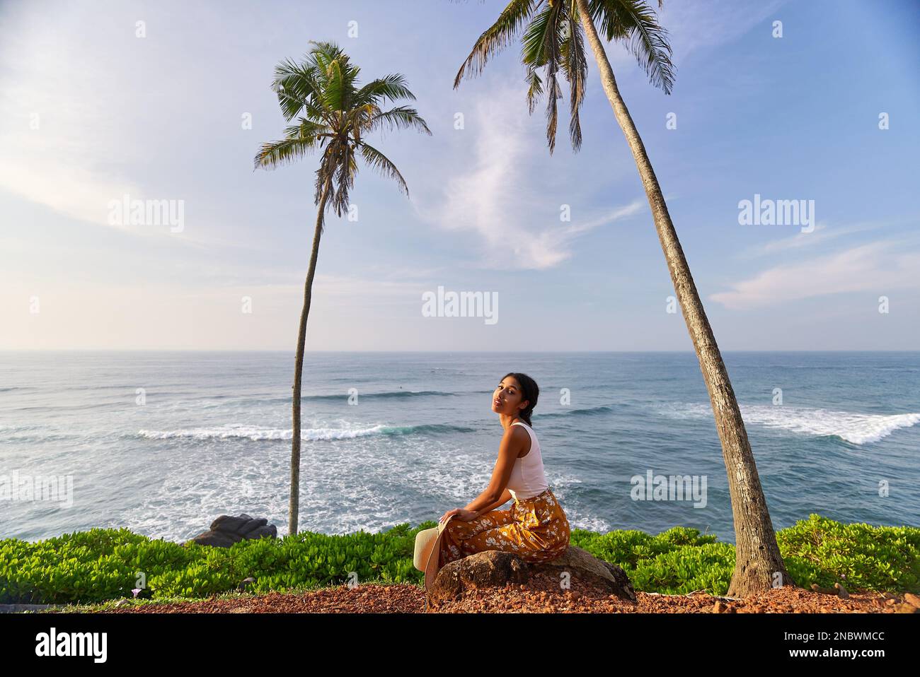 Young african female model posing in colorful clothes at scenic ...