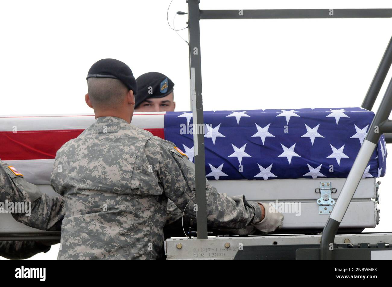 An Army carry team lifts a transfer case containing the remains of Pfc ...