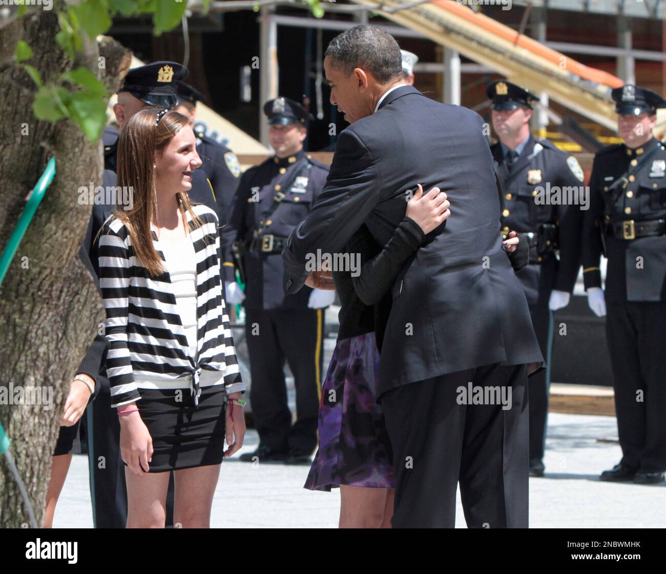 President Barack Obama embraces Payton Wall, as her sister Avery Wall ...