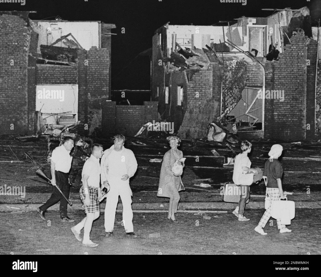 Dazed residents of Topeka, Kansas on June 9, 1966 leave their tornado ...