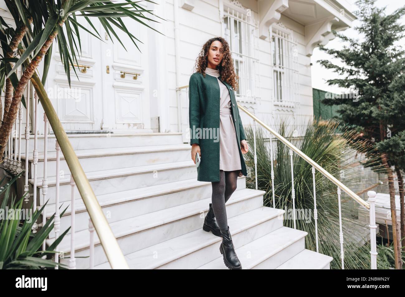 Beautiful young girl model posing near the house Stock Photo - Alamy