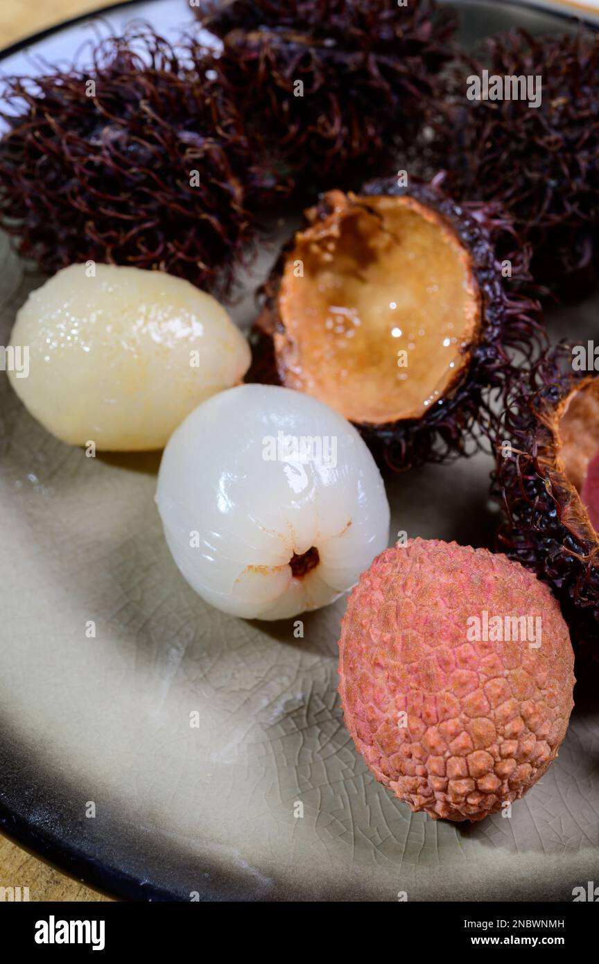 Tasty tropical exotic fruits, sweet ripe fresh peeled and unpeeled ...