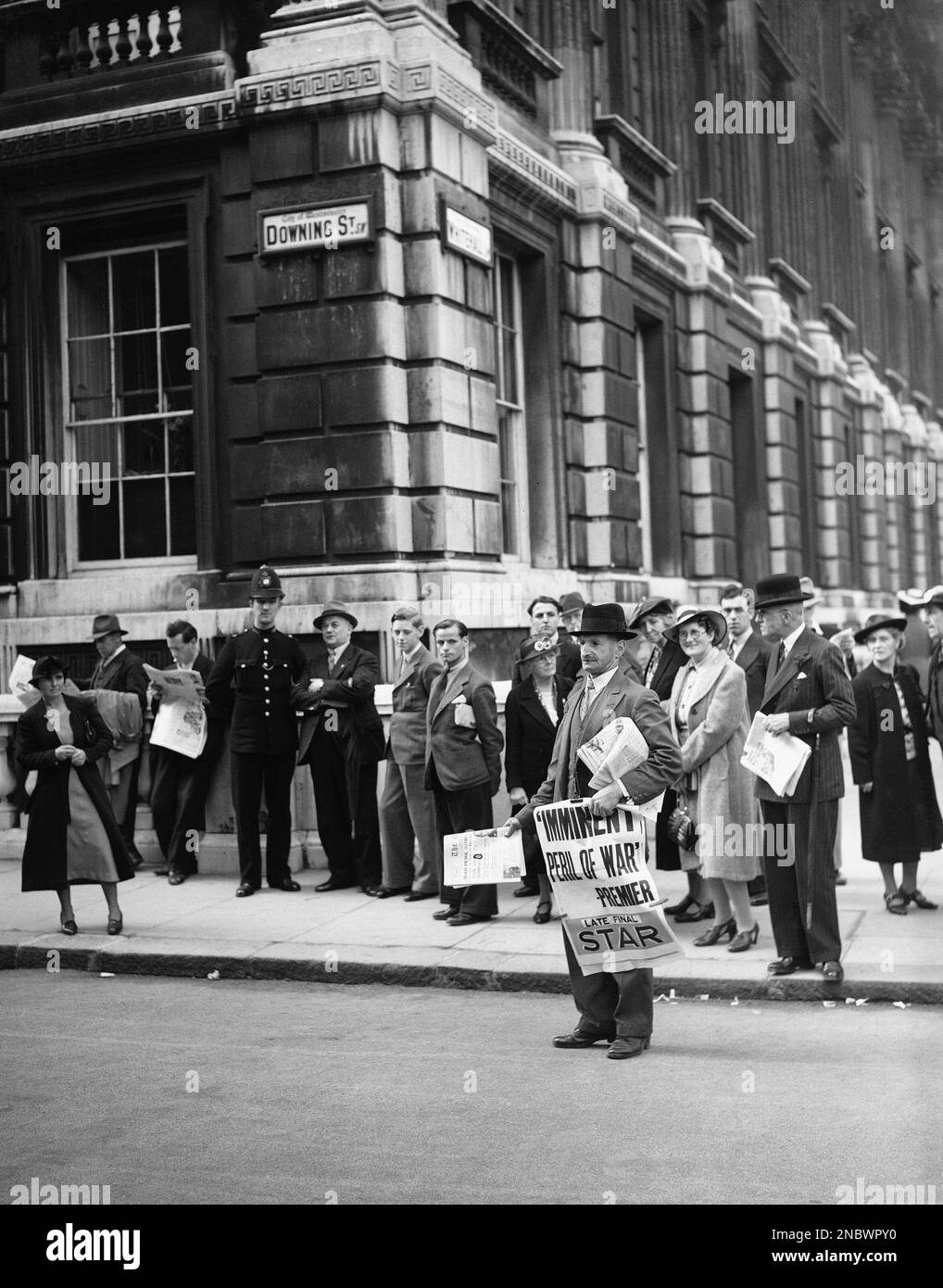 A newspaper seller with his poster announcing the premier’s war ...