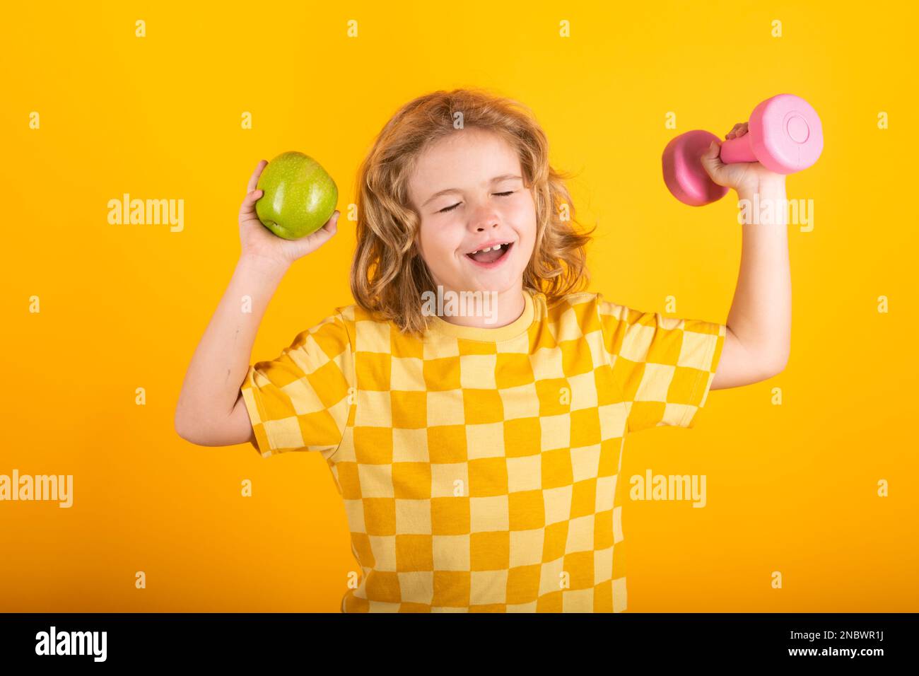 Sport activities at leisure with children. Blonde boy holding dumbbells. Sports exercises for ...