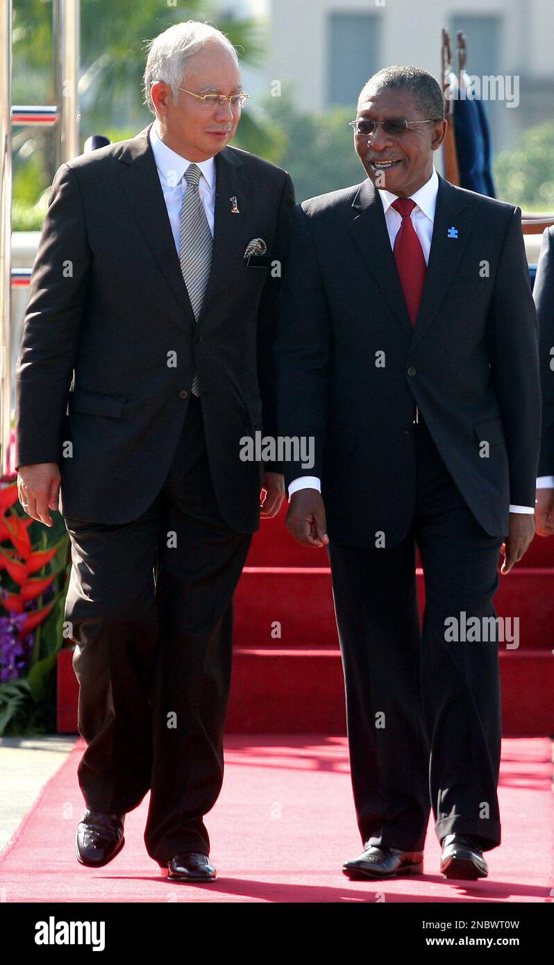 Lesotho's Prime Minister Pakalitha Mosisili, right, walks with his ...