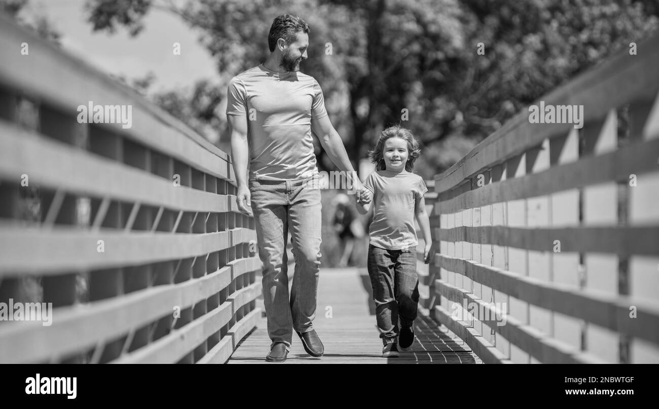 fathers day. cheerful father leading son outdoor. family value ...