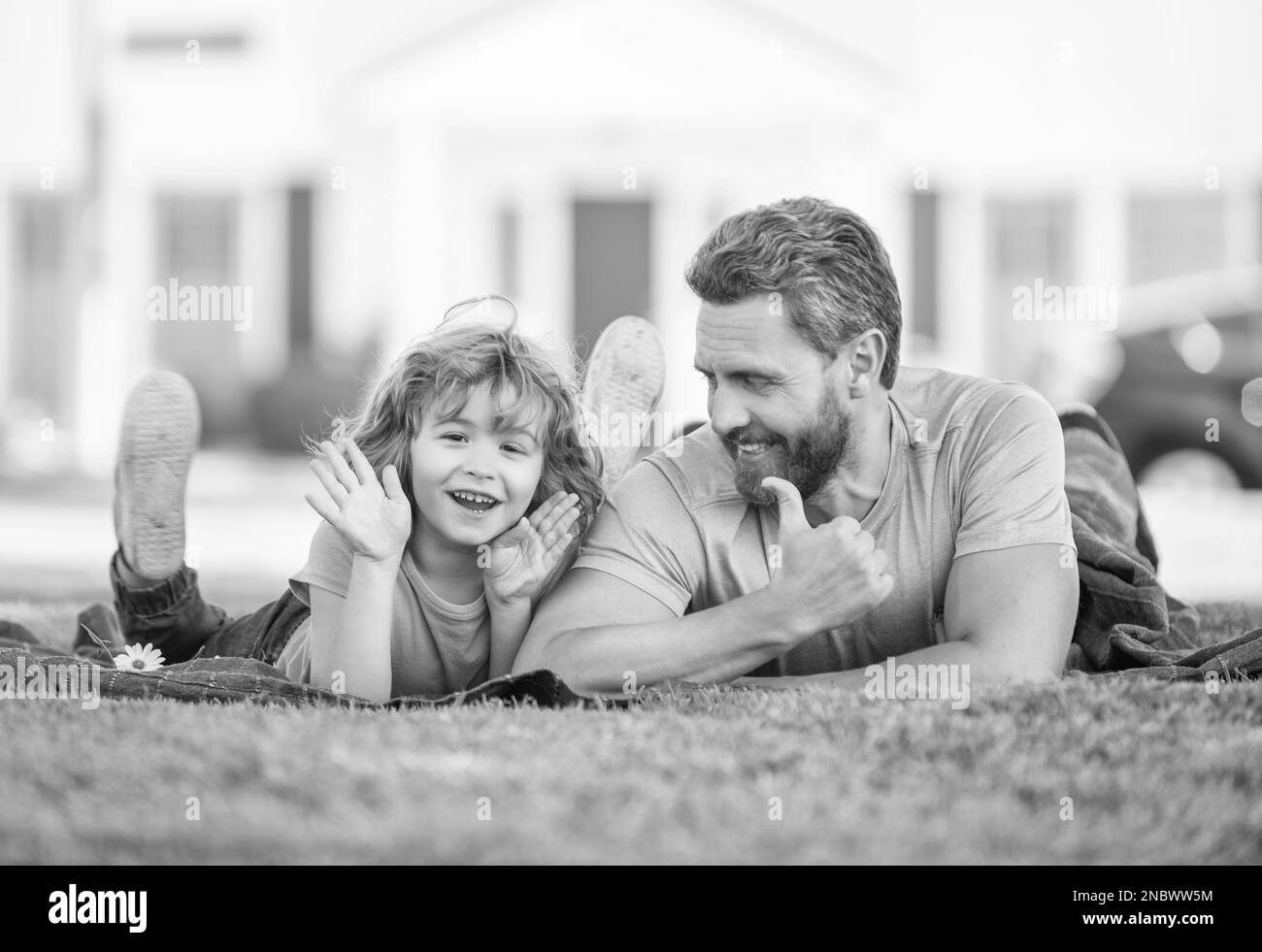 happy father with son relax together on green park grass show thumb up ...