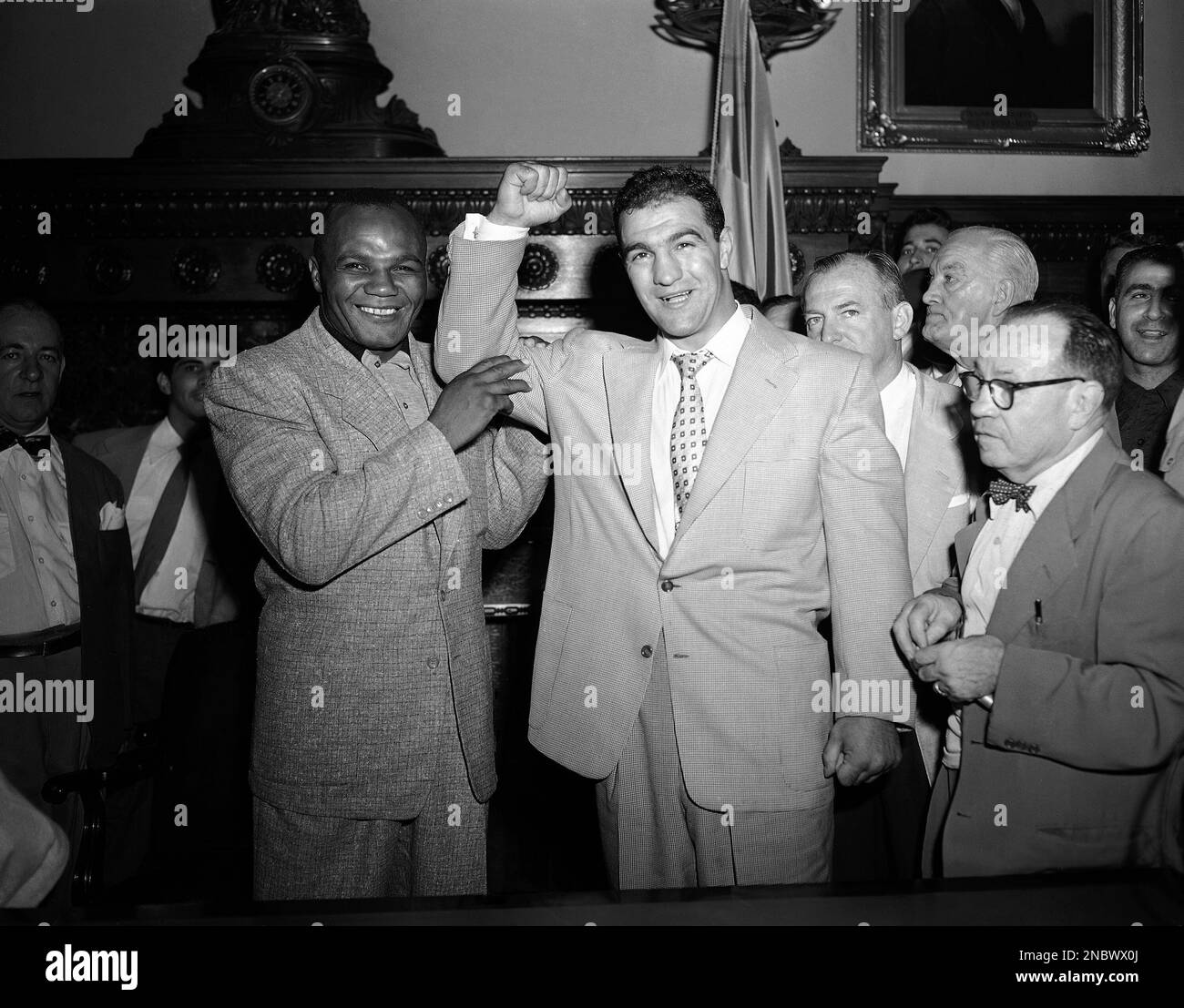 Heavy weight champion Jersey Joe Walcott, left, checks on right muscle ...