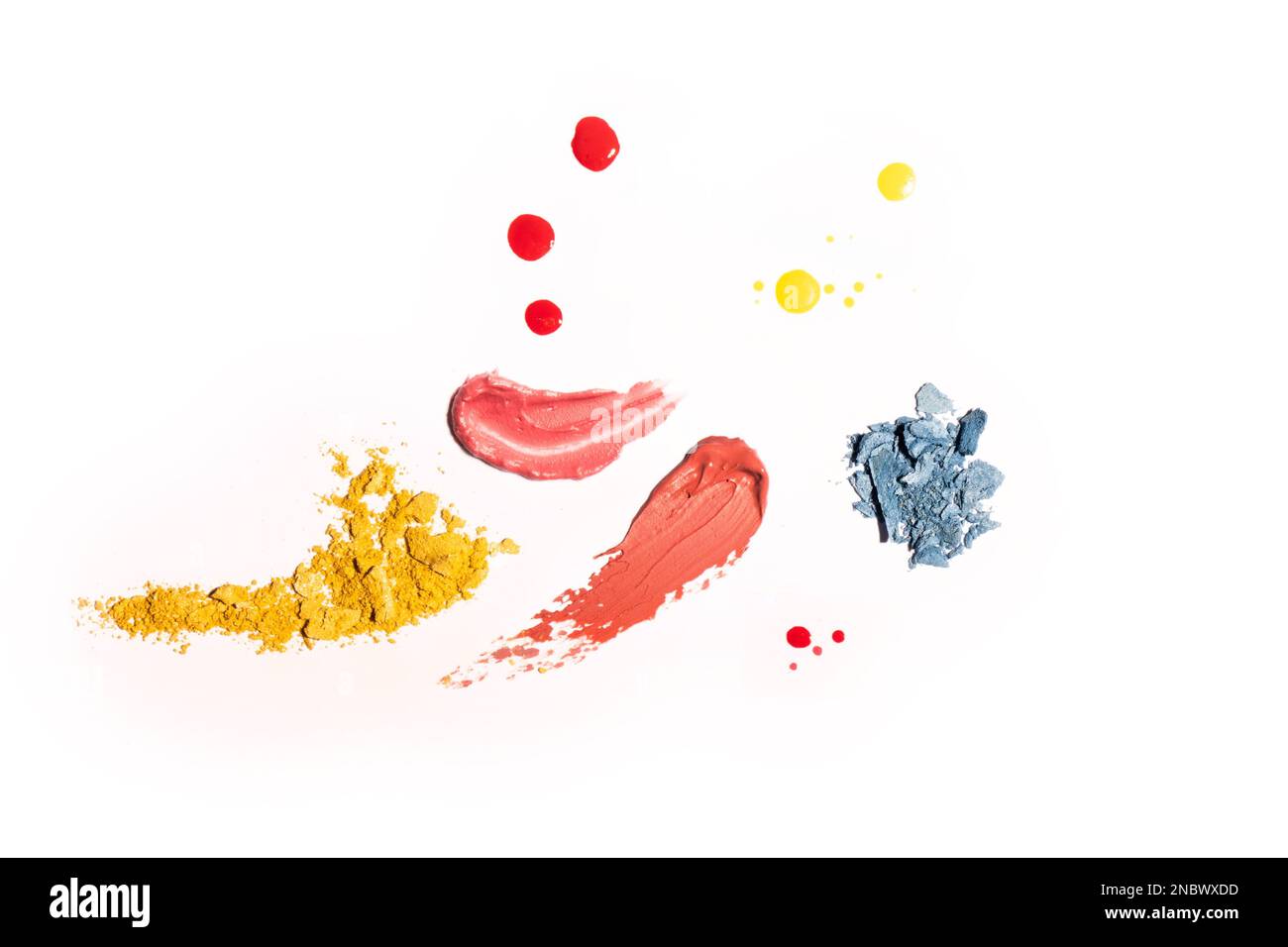 Make-up swatches-yellow and blue powder, pink lipstick, and drops of ...