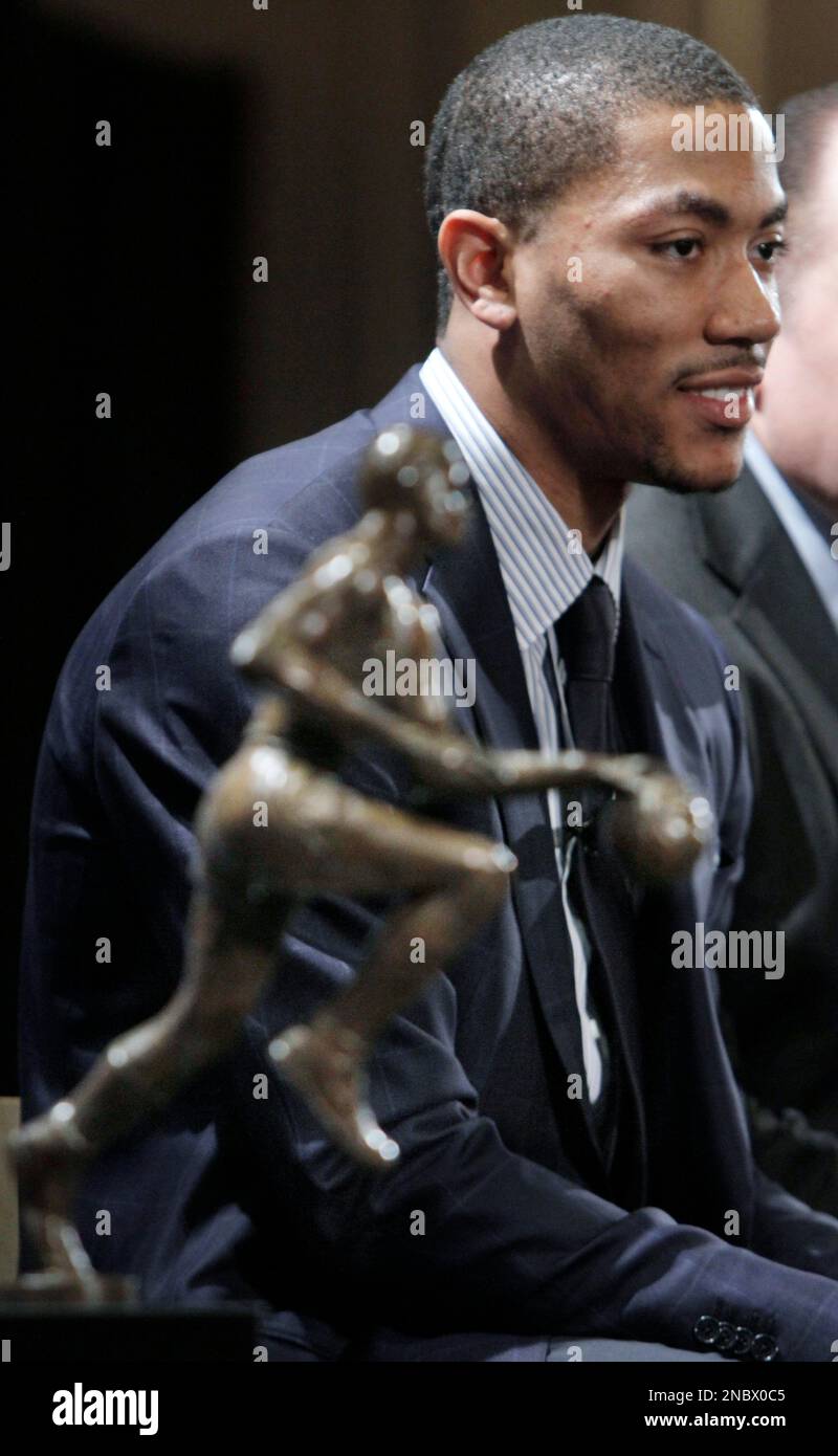 Chicago Bulls' Derrick Rose smiles as he sits next to the Maurice Podoloff Trophy before being ...