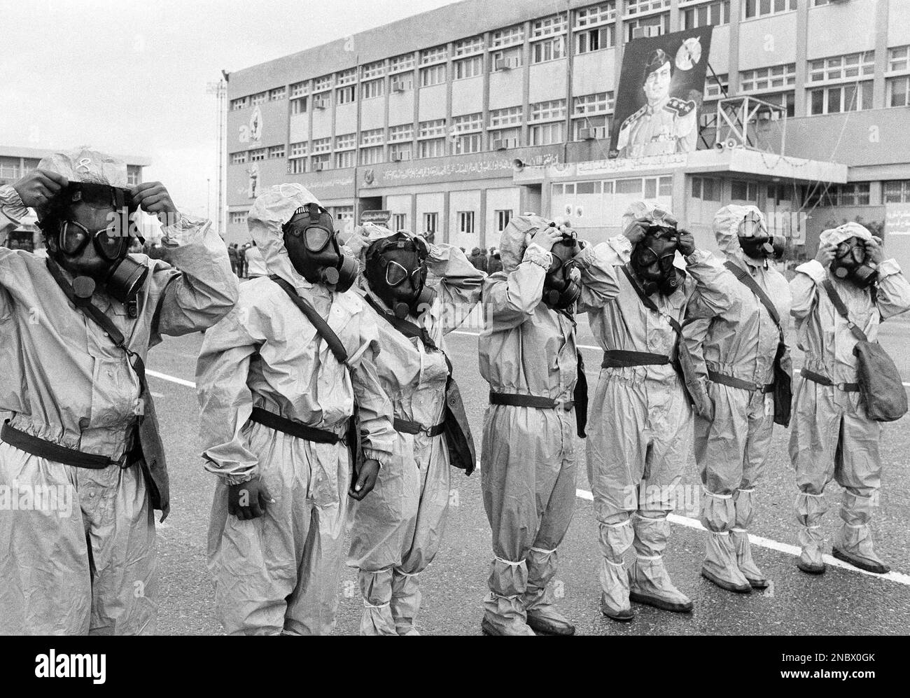 Female soldiers wear protective overalls and masks during a training ...