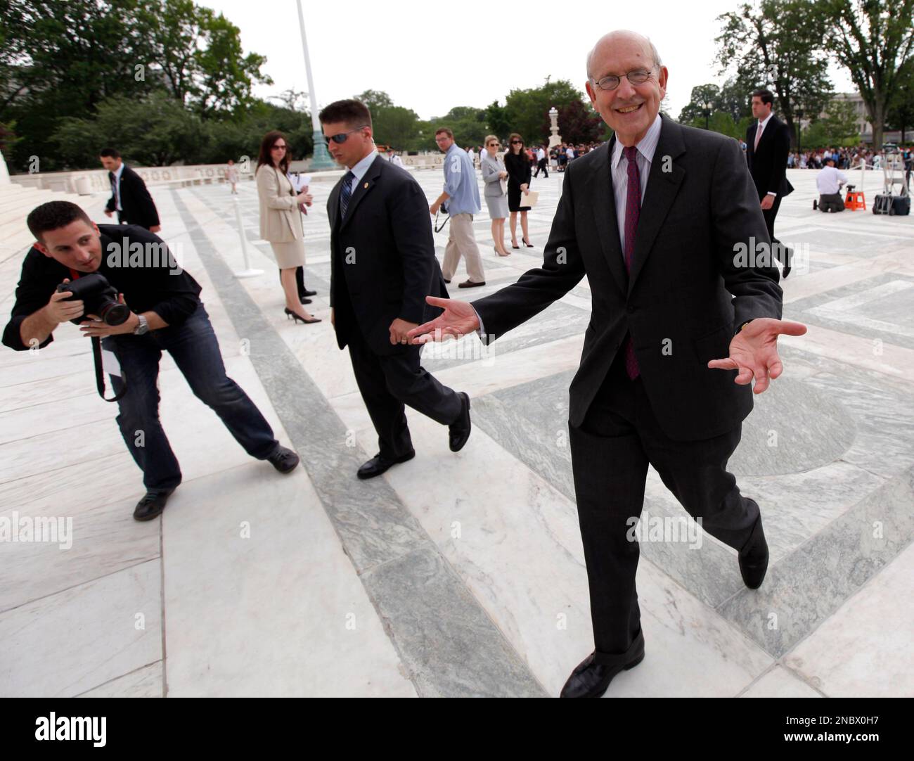 U.S. Supreme Court Justice Stephen Breyer reacts with photographers as ...
