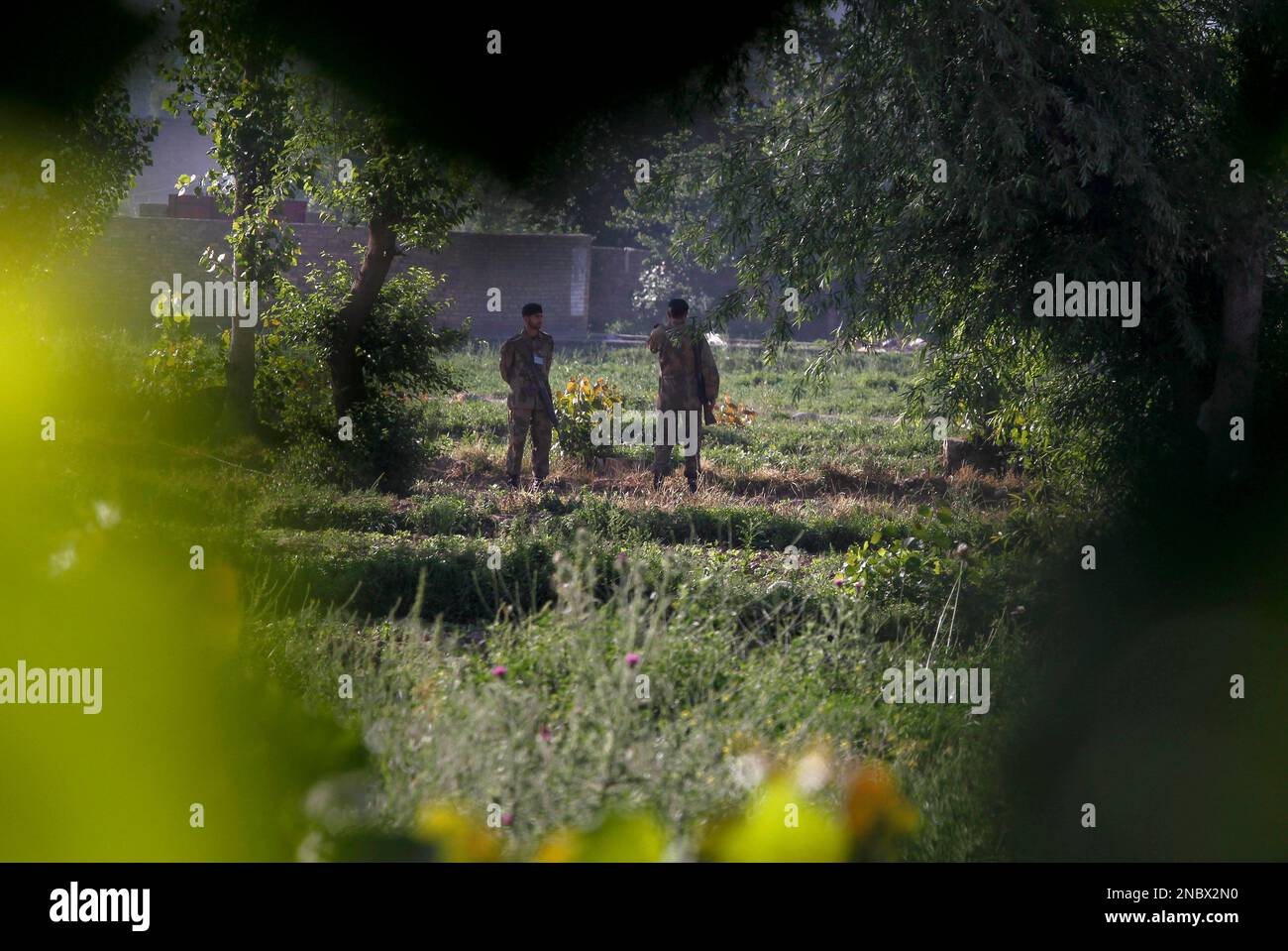 Pakistan army soldiers stand guard near the compound where it is ...