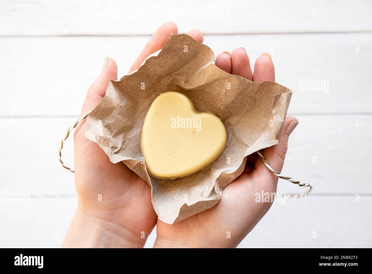 Woman hands holding and applying handmade beeswax and shea butter solid ...