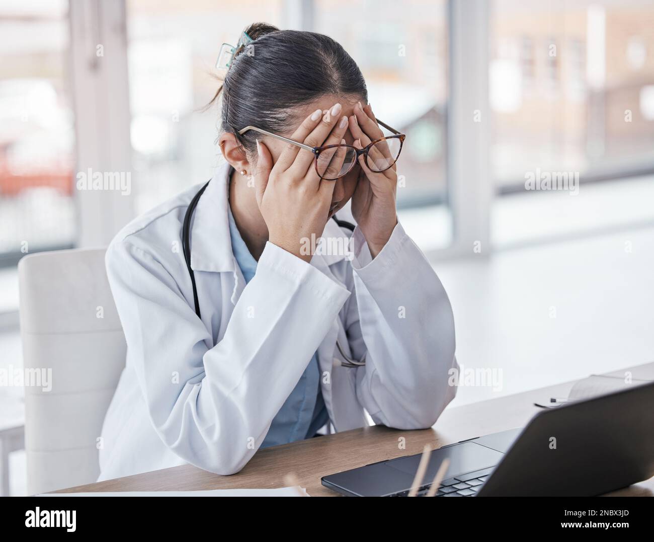 Burnout, stress or doctor woman on laptop with headache from depression ...