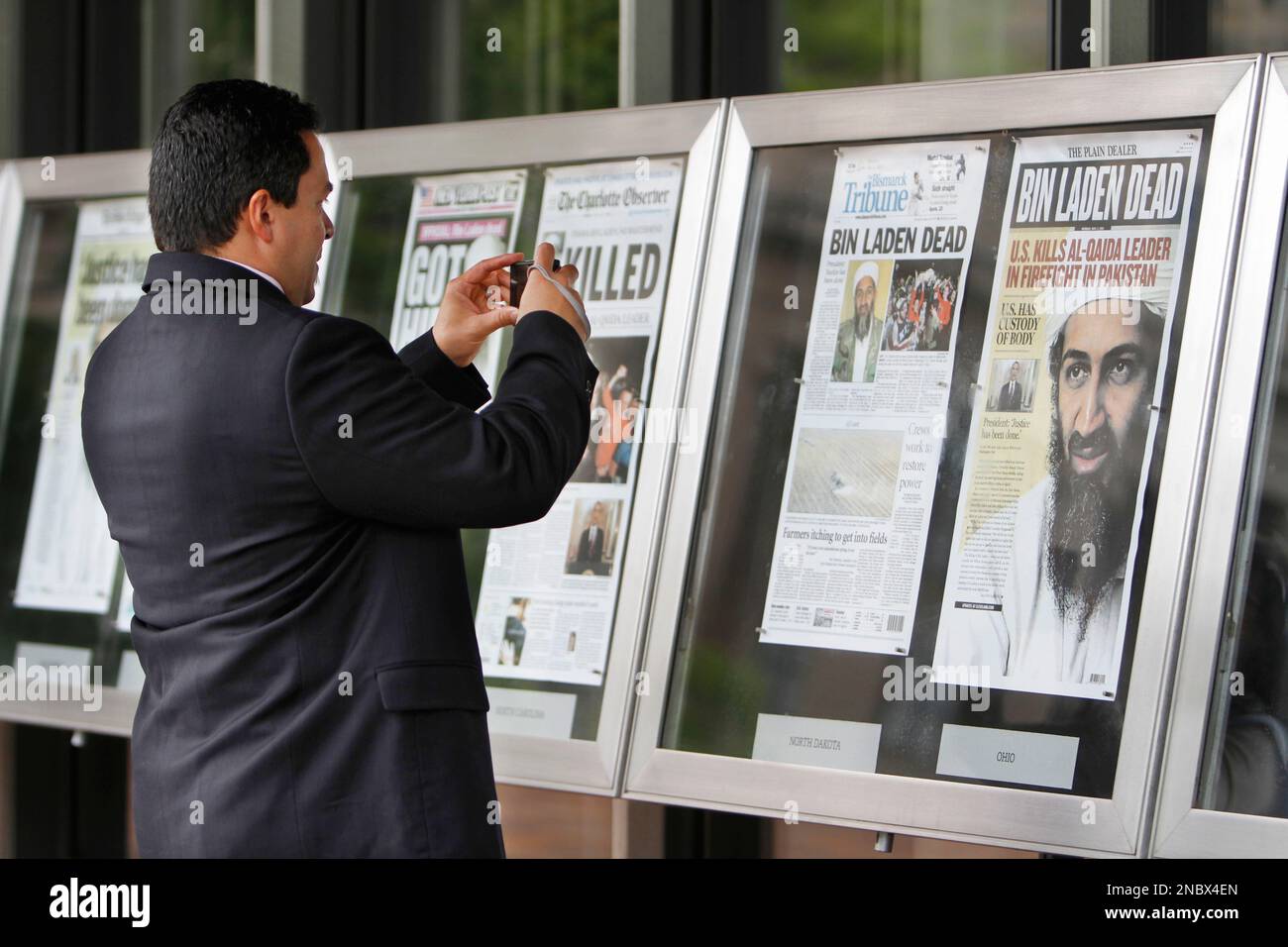 Raul Matias, of Woodbridge, Va., looks at a display of newspaper front ...