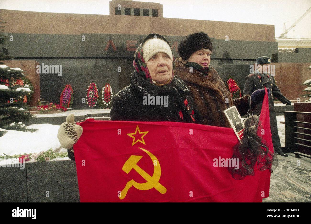 Two women, Communist supporters hold the flag of the former Soviet ...
