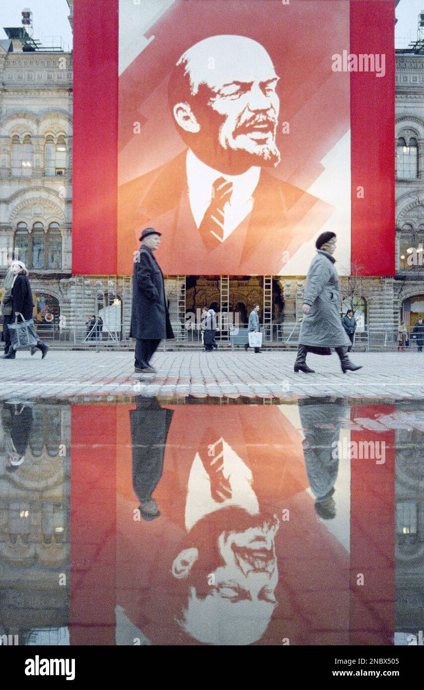 Soviet citizens walk pass the giant Vladimir I. Lenin portrait in ...