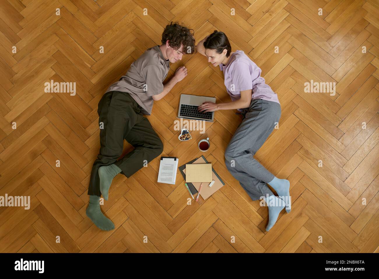 Top view of young caucasian couple in love smiling laughing looking at ...