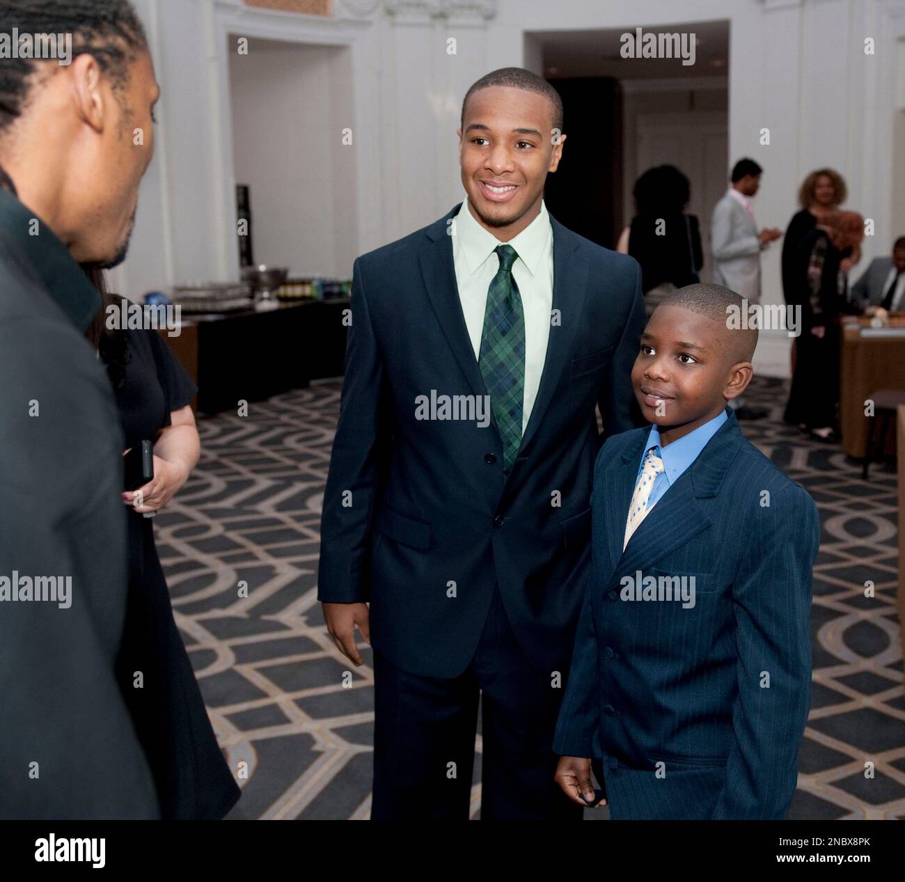 LaShaun Armstrong, right, and is uncle Tymare Armstrong greet a guest ...