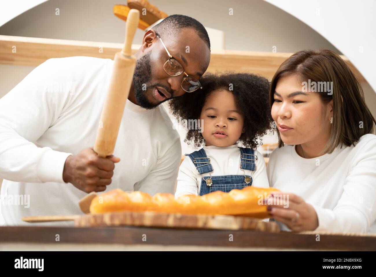 African family, father, mother, daughter doing various activities ...