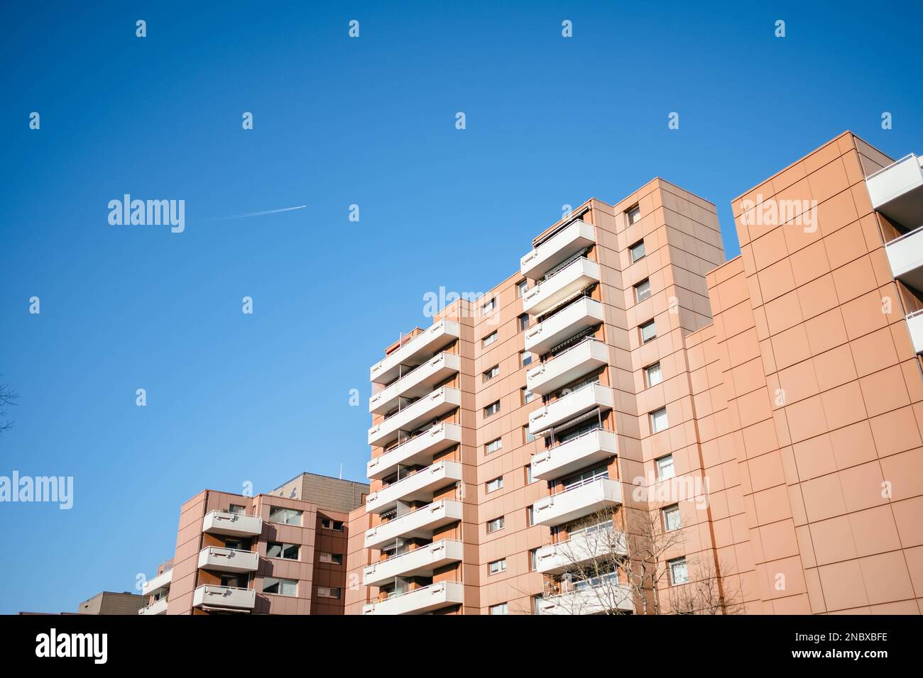 A prefabricated house in the ghetto under a blue sky. The high-rise ...
